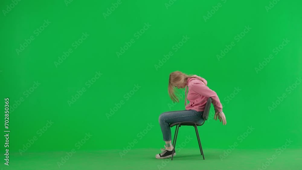 Portrait of victim on chroma key green screen background. Girl sitting ...