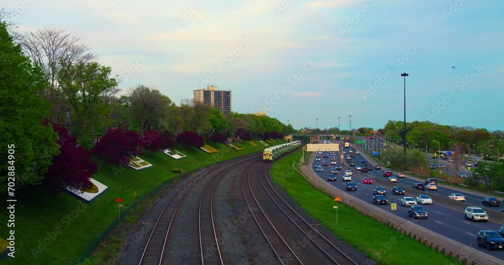 Train on railroad parallel to bustling highway aerial view Life thrives ...