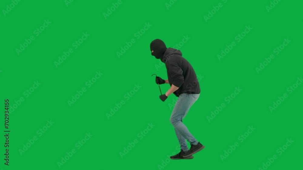 Portrait of thief on chroma key green screen background. Man robber in ...