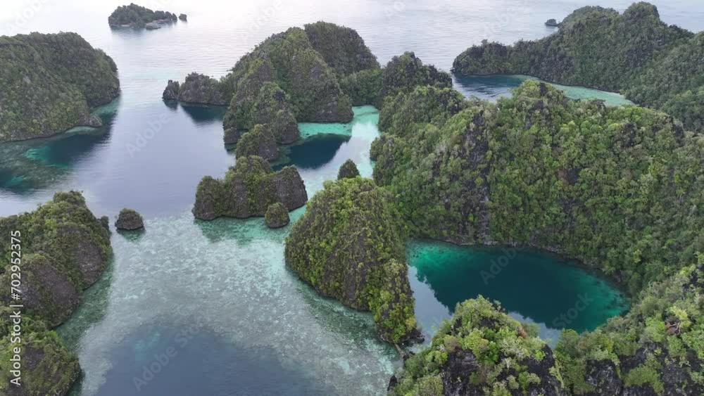 Rugged, limestone islands, fringed by reefs, rise from the scenic ...