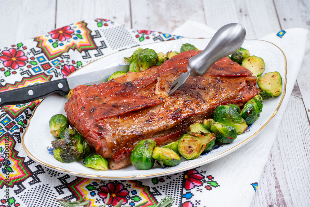 Vegan pork belly roast made with seitan and starch, served on oval ...