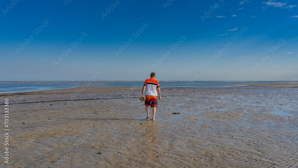 The low tide in the ocean. Puddles of water on the exposed undulating ...