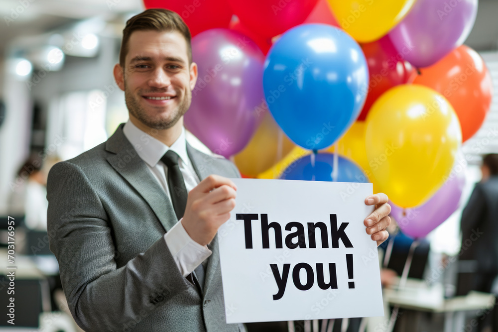 Thank you concept image with a business man manager holding a sign with ...