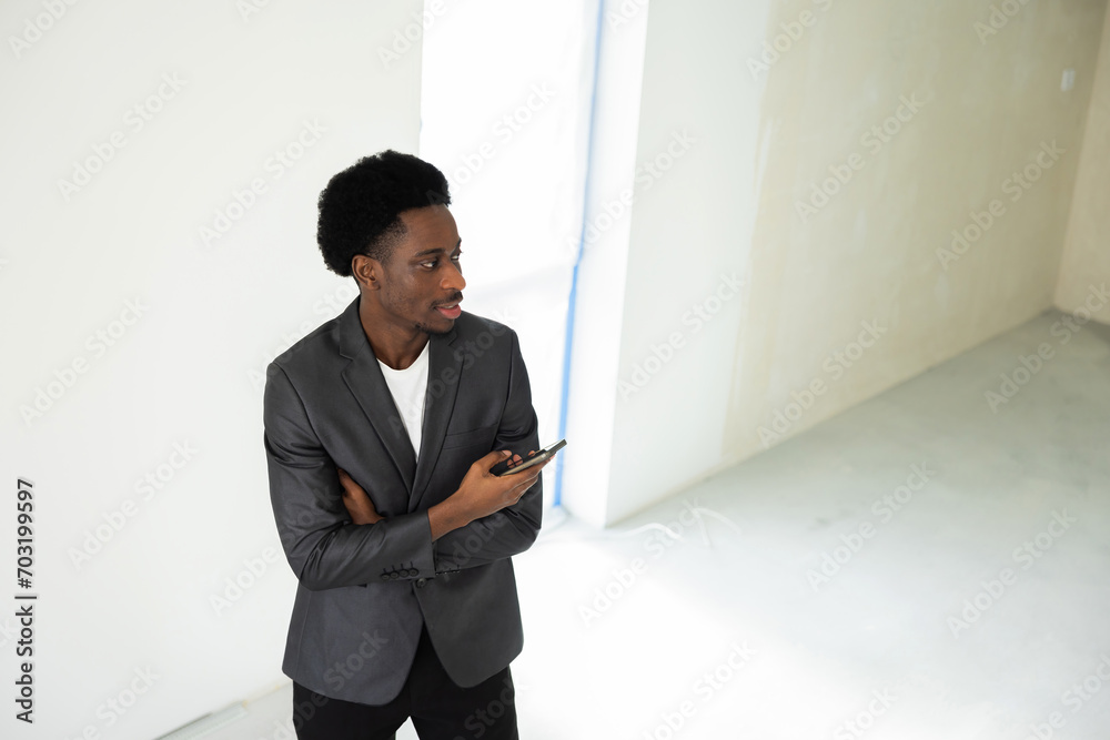 Happy dark skinned black african american client standing in new ...