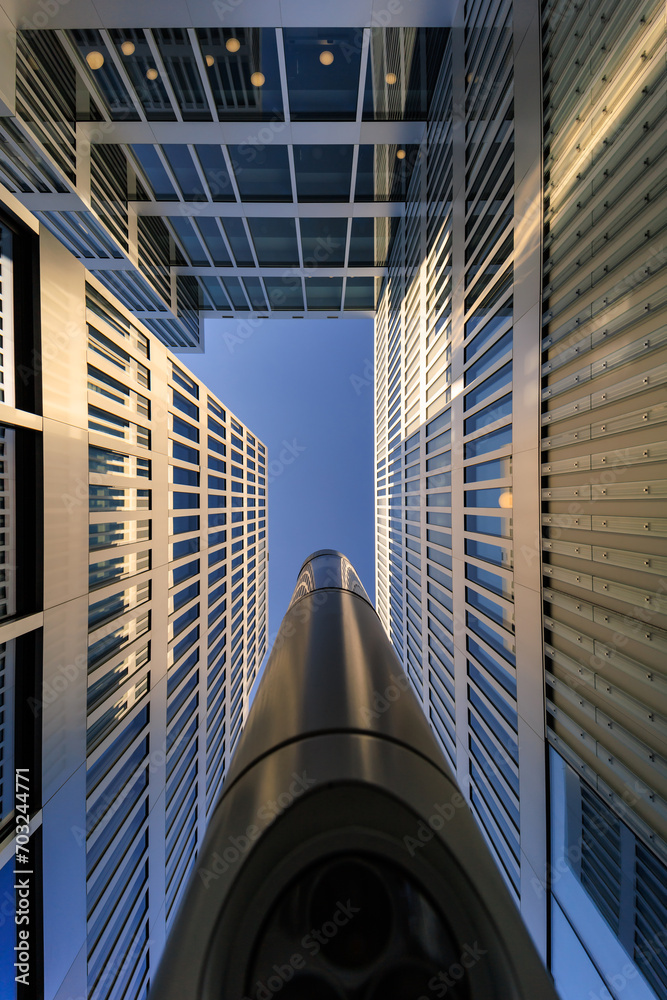 golden reflected sunlight from building facades, lookup view of modern ...