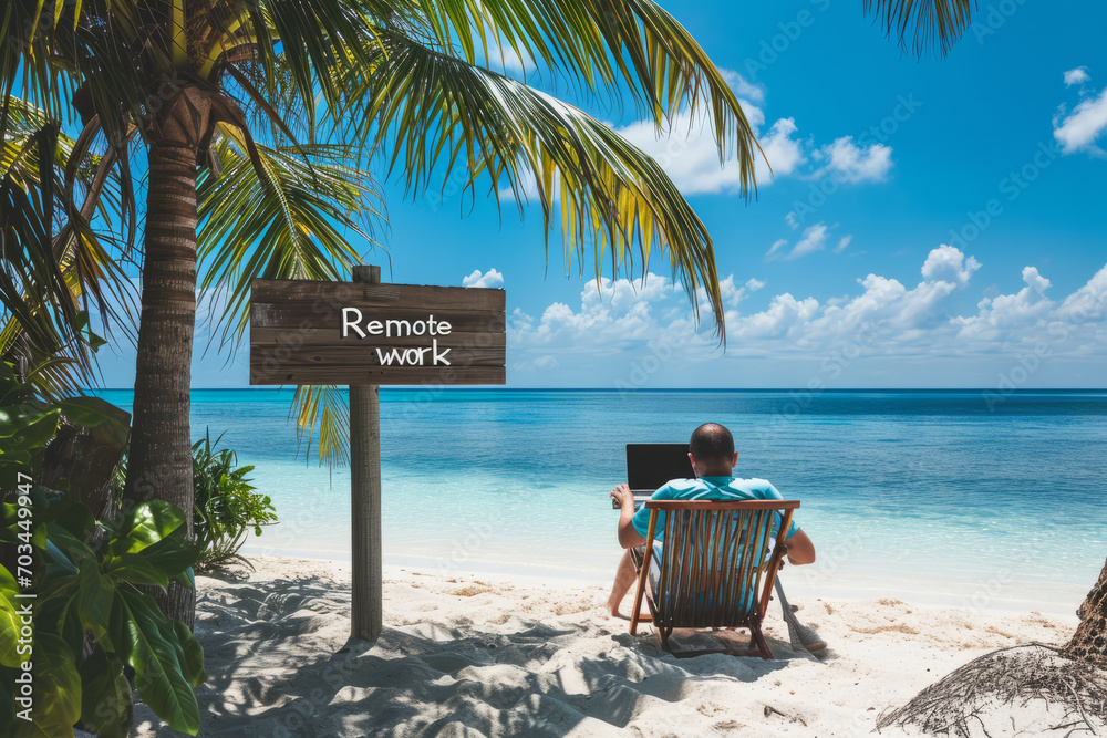 Remote work concept image with a man working from the beach on his ...