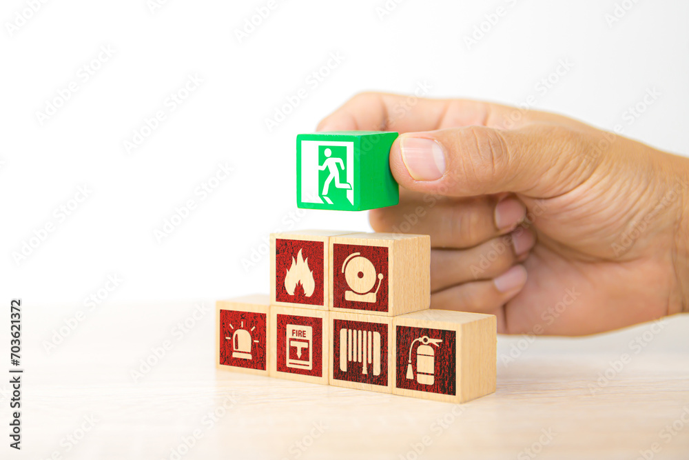 Fire prevention concept on cube wooden toy block stack with door exit ...