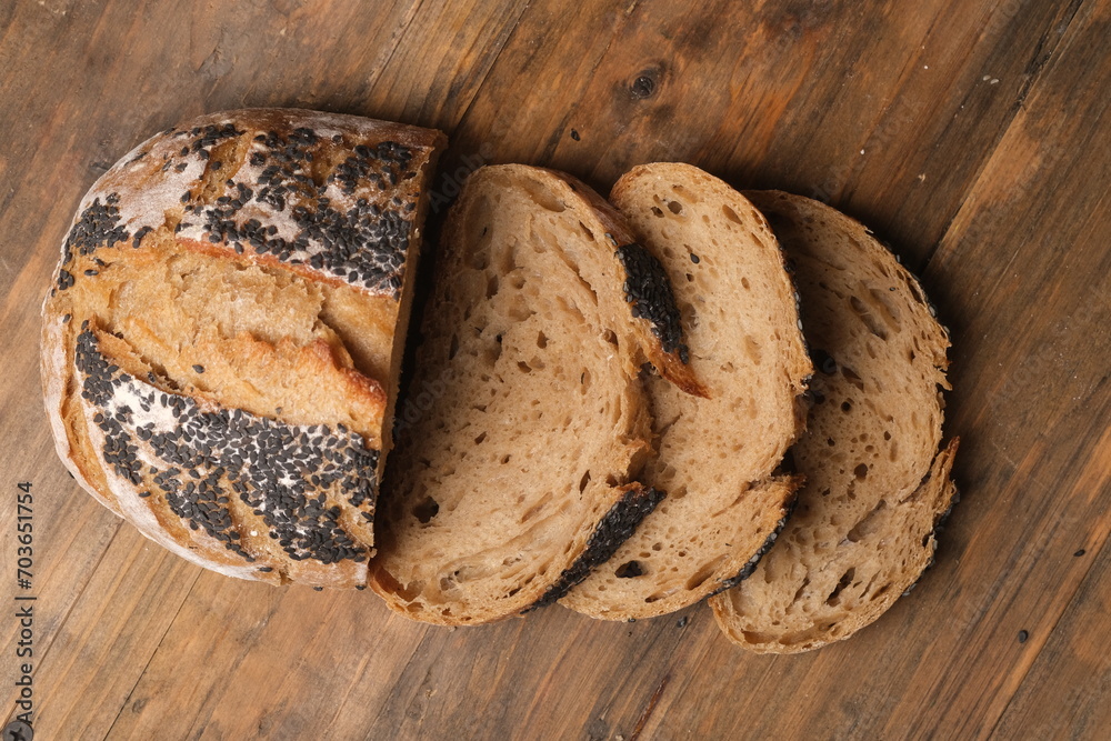 Sourdough bread on the rustic table. Sourdough is a bread made by ...