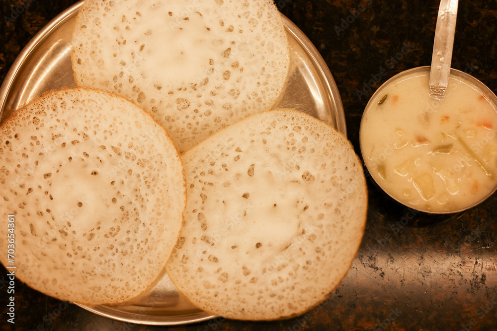 Appam, Kerala breakfast food egg curry or hot and spicy chickpea Masala ...