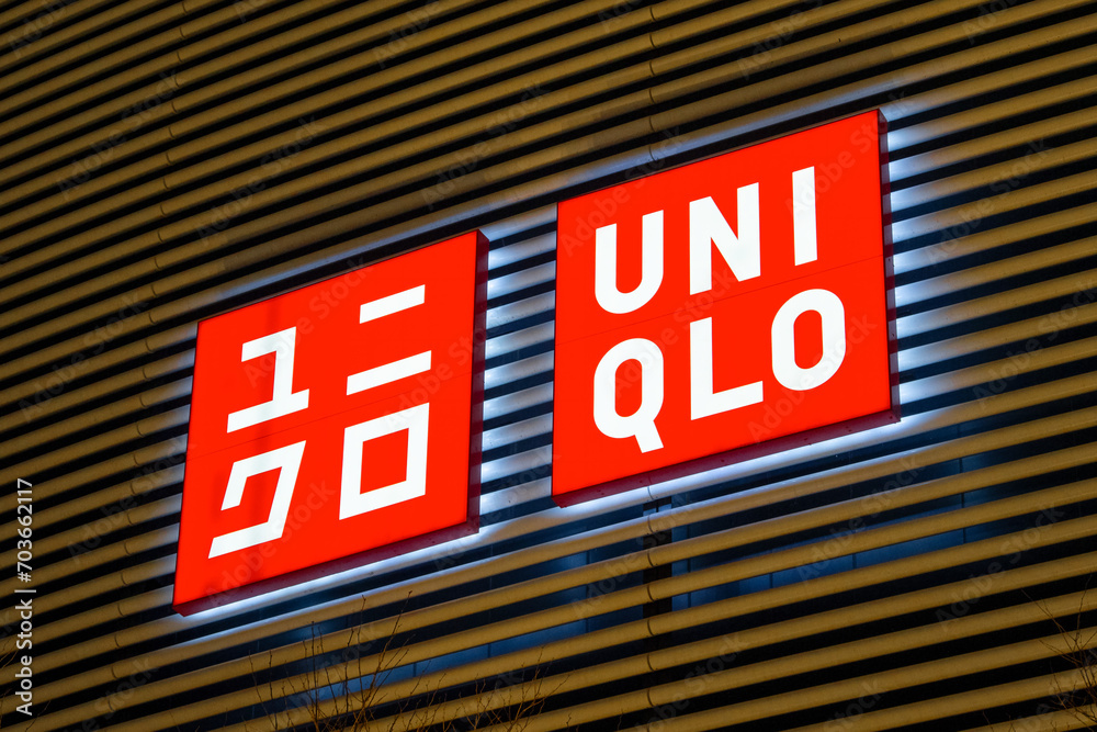 Store sign with UNIQLO logo. UNIQLO is a Japanese apparel brand ...