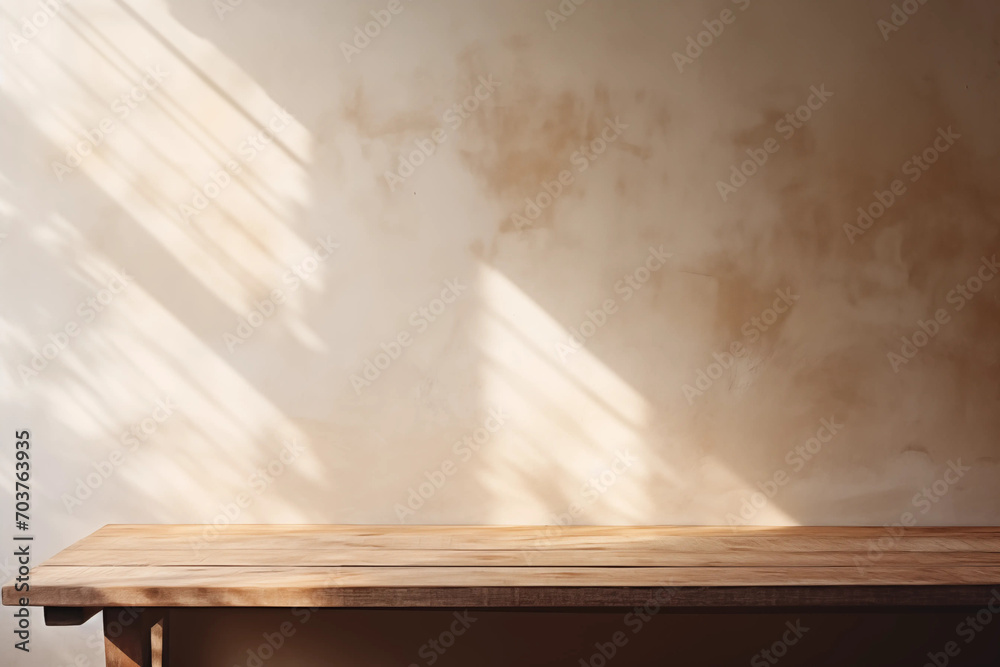Empty wooden table top near stucco wall with with sunlight falling from ...