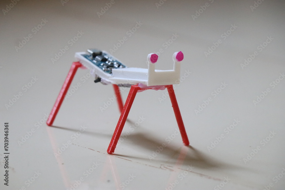 Small sized robot with four legs made using 3d printing technology and ...