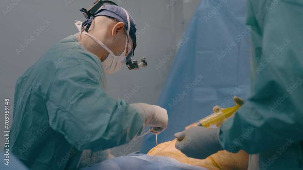 Doctor man physician surgeon perform plastic surgery liposuction ...
