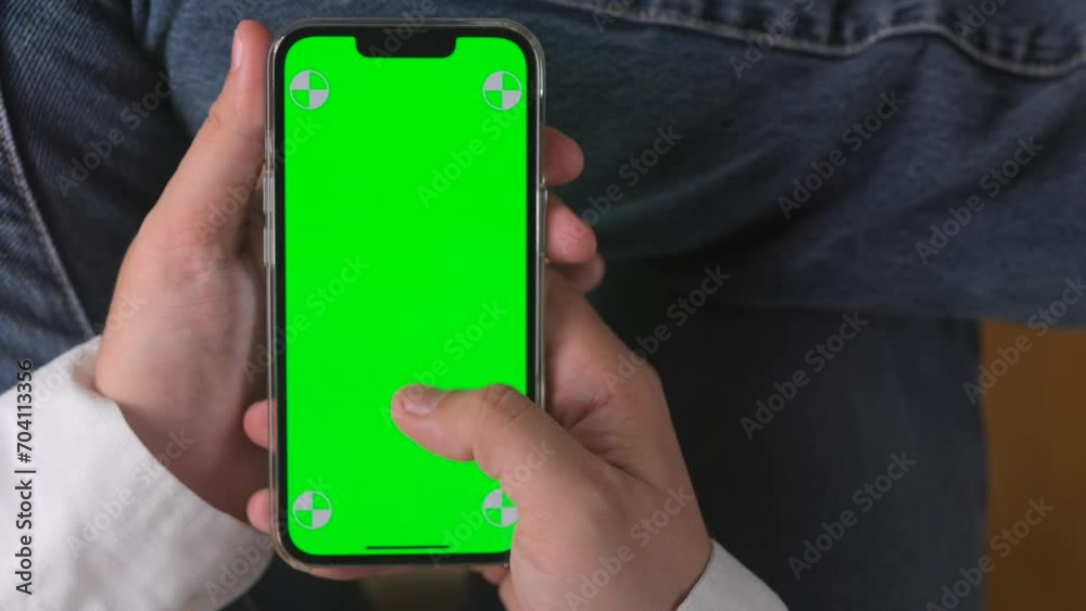 Scrolling, swiping, surfing on a smartphone with a green screen and motion tracking for app ...