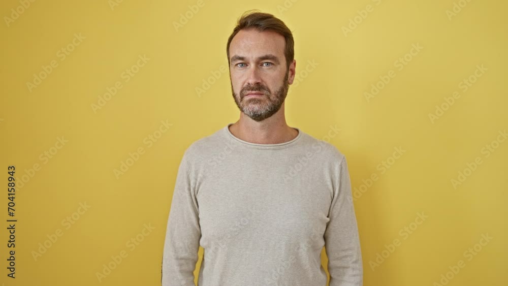 Hispanic man, standing tall, expressing a natural, simple look. serious ...