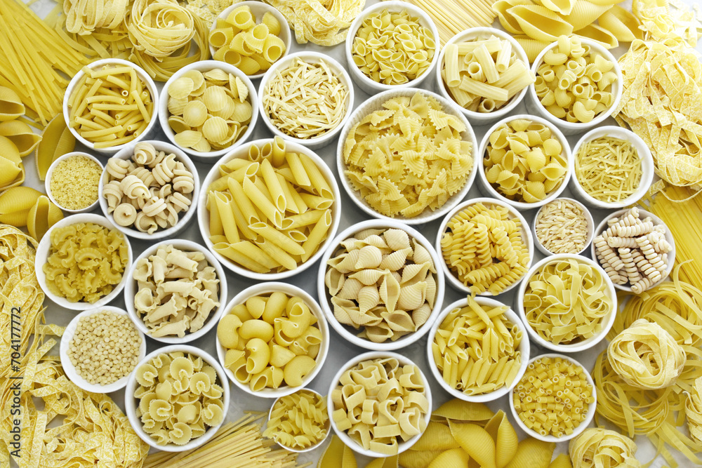 Mix of pasta shapes varieties: penne and fusilli, farfalle and macaroni ...