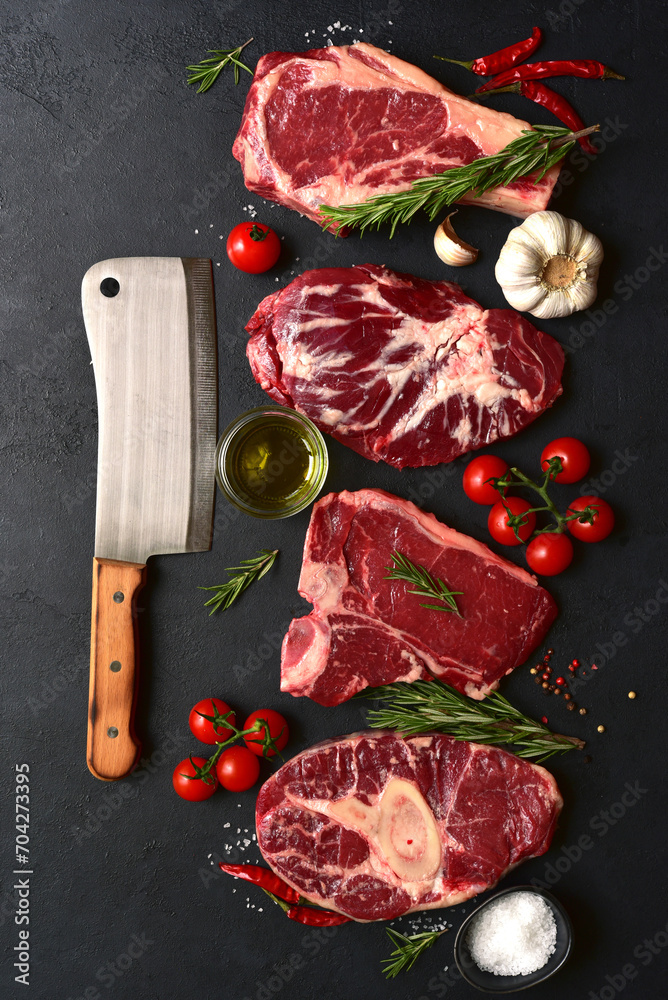 Different types of raw marbled beef steaks : T-bone, ossobuko, spider ...