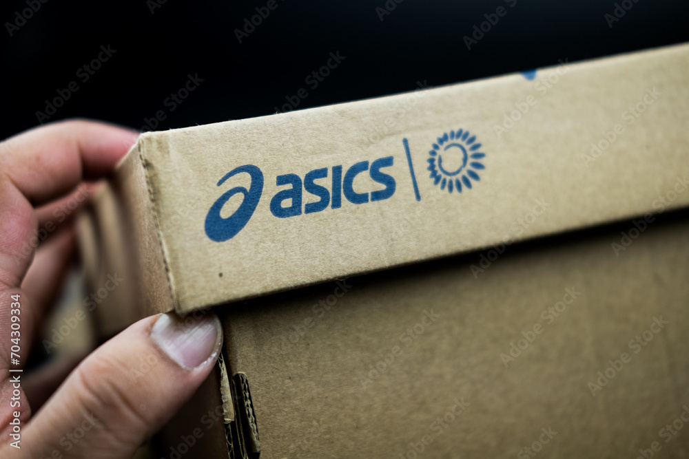 Bangkok, Thailand - January 7, 2024 : Man hand open shoe box with Asics ...
