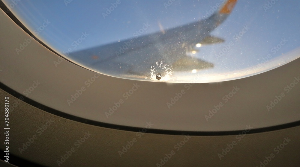 Hole in the airplane window. The hole helps regulate how much pressure ...