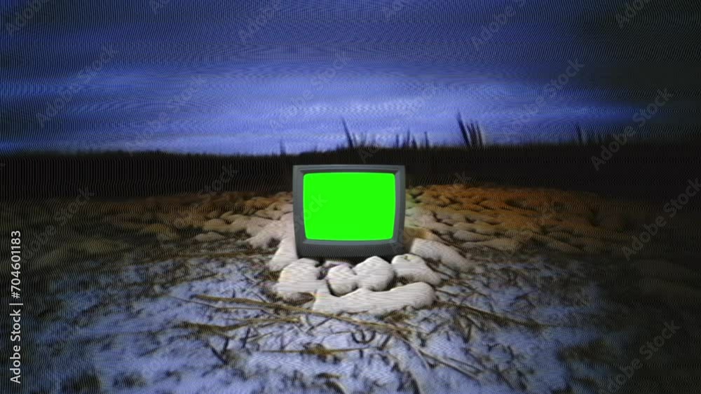Classic television with a luminous green screen, barren landscape under ...