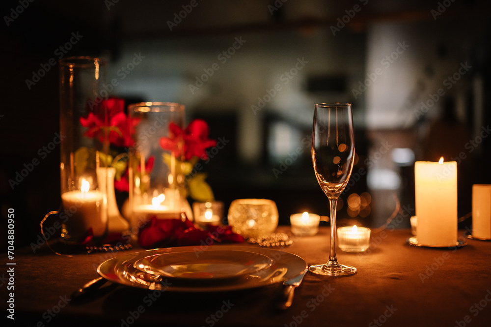 Candlelight date in restaurant. Champagne glasses, bouquet flowers ...