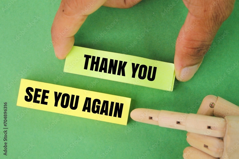 finger holding colored paper with the words thank you and see you again ...