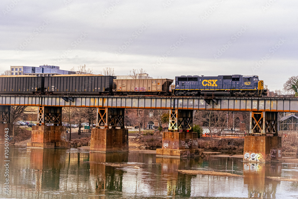 CSX Locomotive Engine pulling a coal and freight train alongside the ...