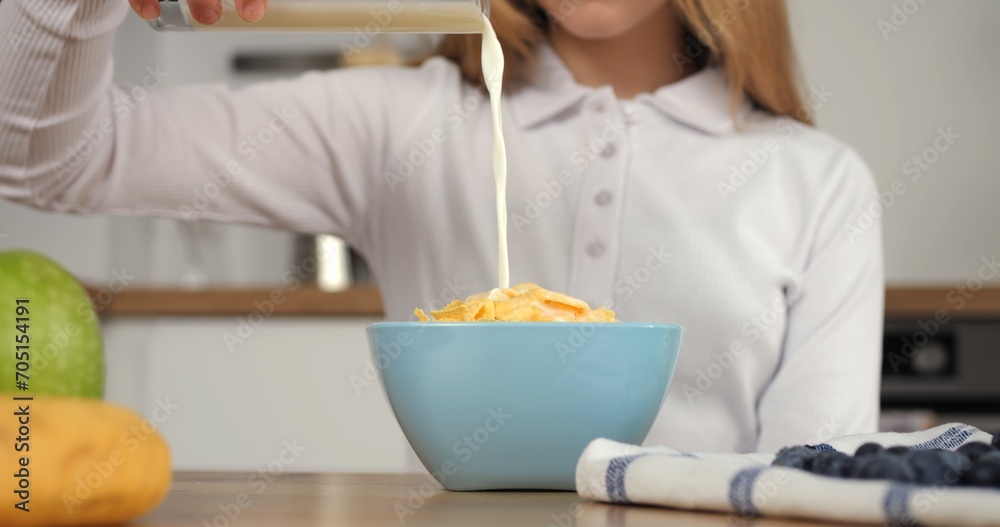 In modern kitchen girl's healthy eating ritual unfolds Slowly pouring ...