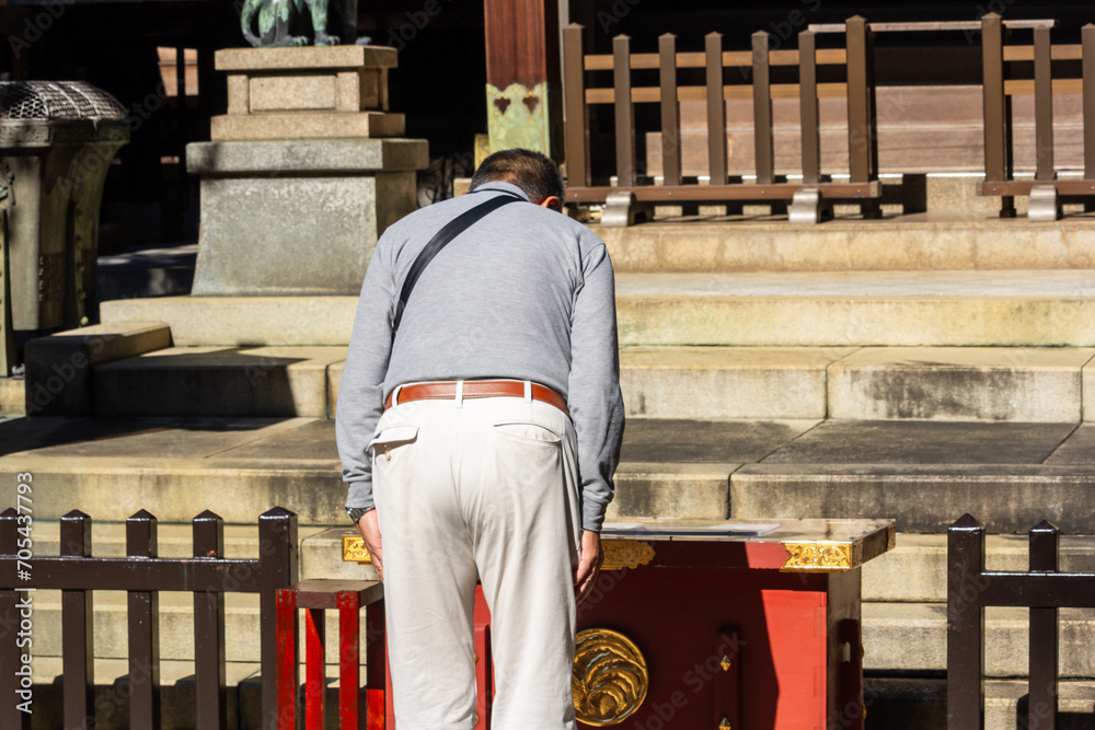 Tokyo, Japan, 30 October 2023 : Man praying at the altar of a Shinto ...