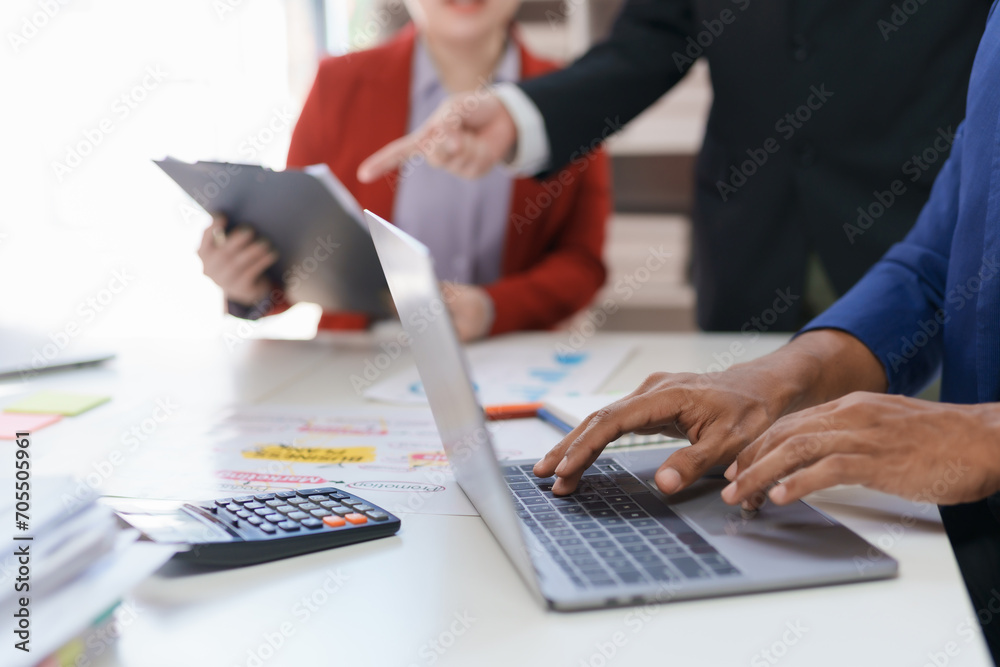 Business representatives meeting pointing on laptop computer. Business ...