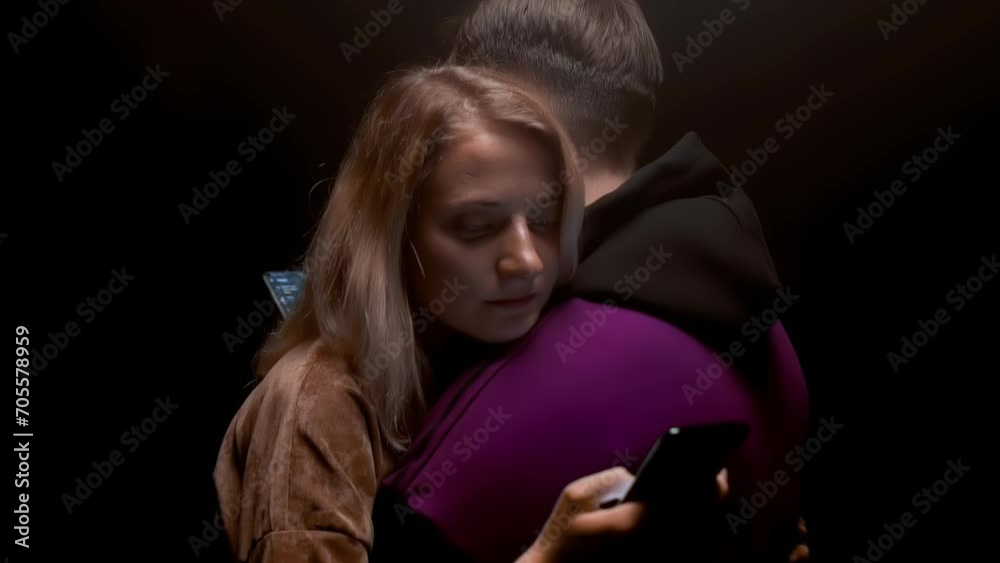 Gadget addiction, relationship problems concept. Girl and guy hugging ...