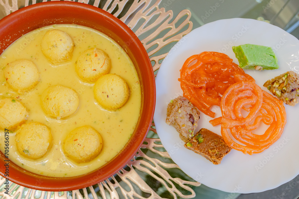 Top view of a traditional Indian dessert. Ras malai balls with sauce in ...