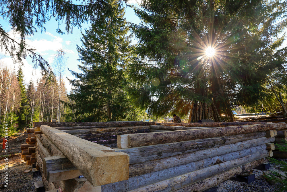 Stages of wood assembly of wooden log house at a construction base into ...