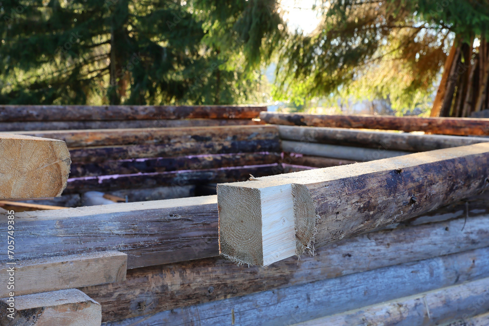 Stages of wood assembly of wooden log house at a construction base into ...