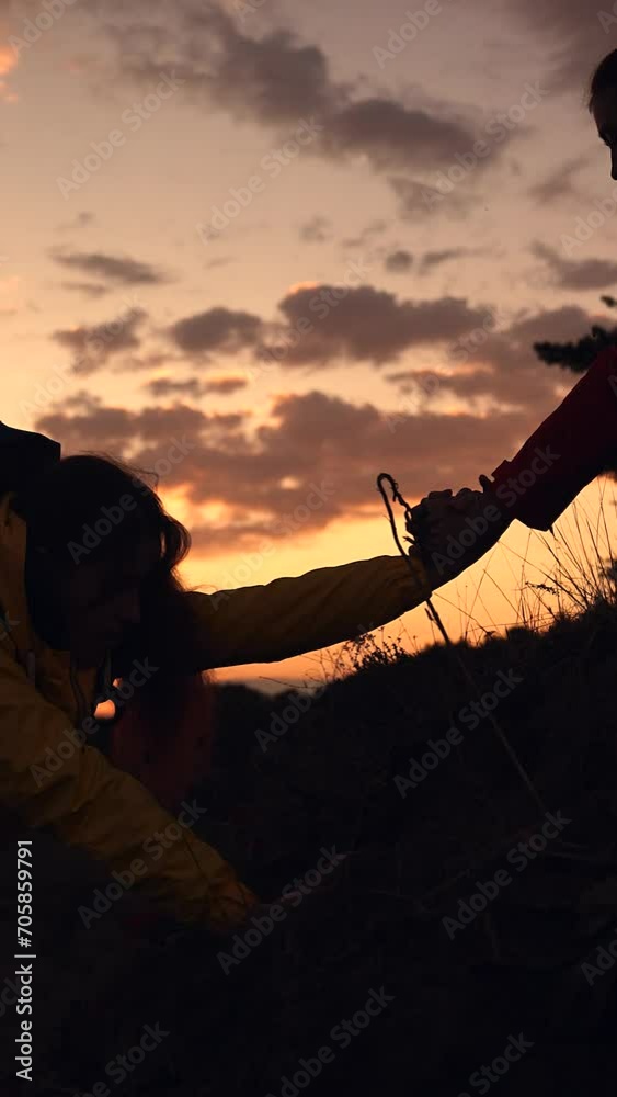 Team of businessmen, victory. Lend helping hand. Travelers climb one after another on rock ...