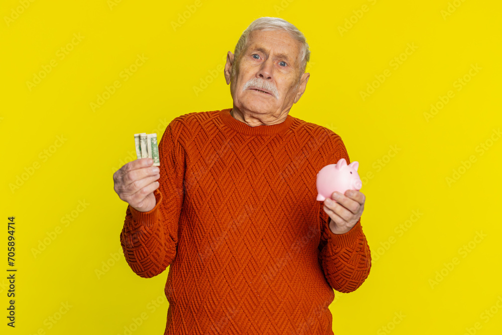 Poor senior old man insufficient amount of money, holding piggybank and ...