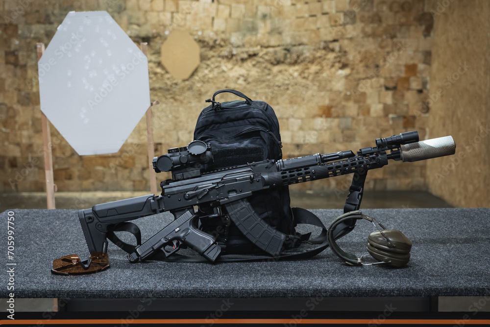 Tactical shooting and firearms in a shooting range, AKM rifle with ...
