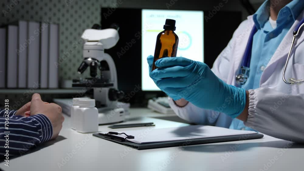 Medical development laboratory, scientists wearing gloves under a ...