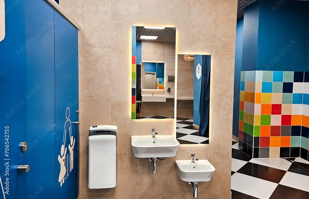 Shared family bright restroom in airport, mall. Unisex WC for mom, dad ...