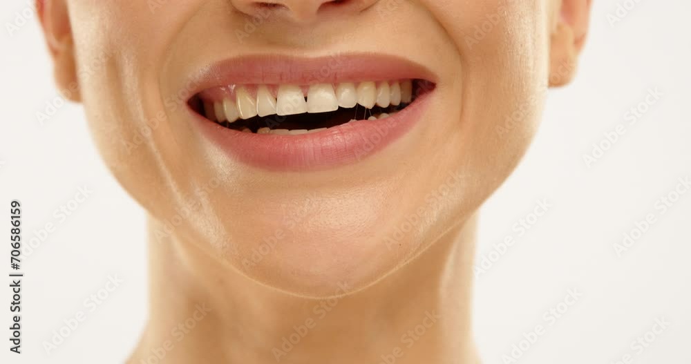 Close up of the lower part of a girl's face with a beautiful smile. She ...