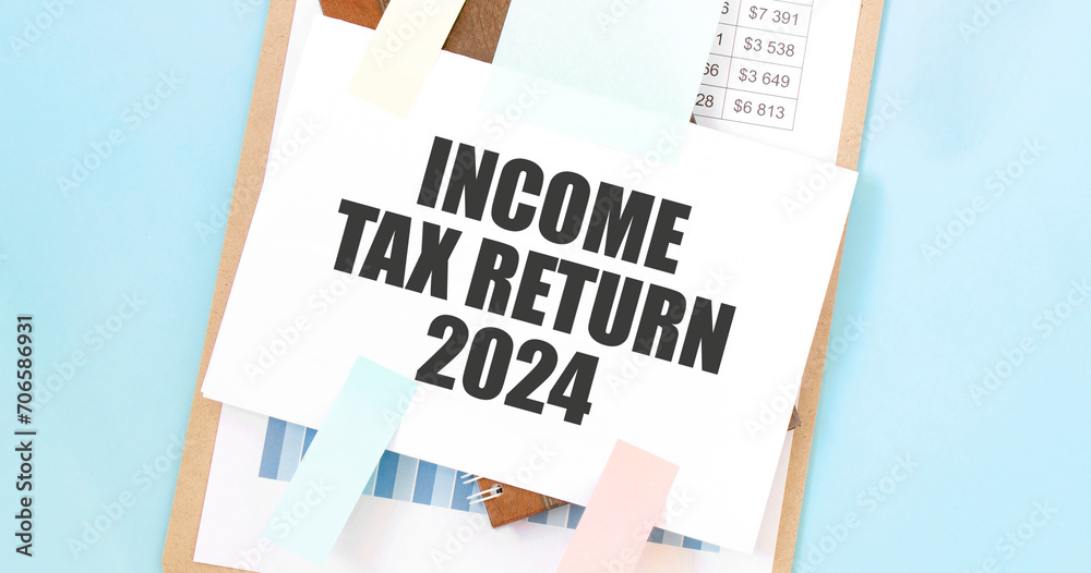 Paper plate with text take INCOME TAX RETURN 2024. Diagram, notepad and ...