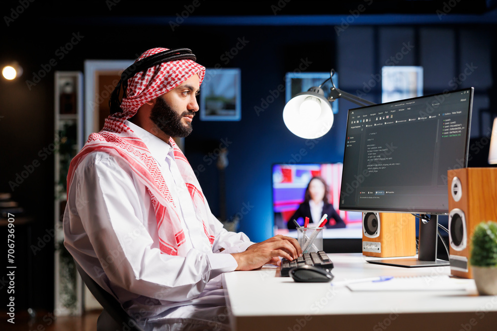 Side-view of Muslim developer writing code on desktop pc, parsing ... Side-view of Muslim developer writing code on desktop pc, parsing ...