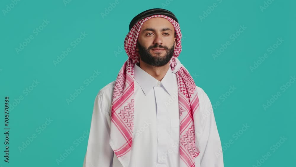 Middle eastern person gives thumbs up in front of camera, expressing ...