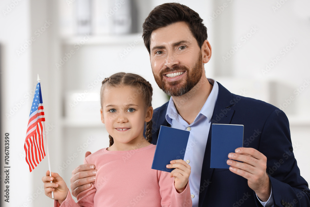 Immigration. Happy man with his daughter holding passports and American ...