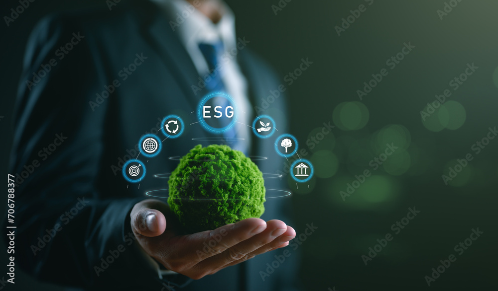 Businessman holding globe with ESG icon green earth concept for ...
