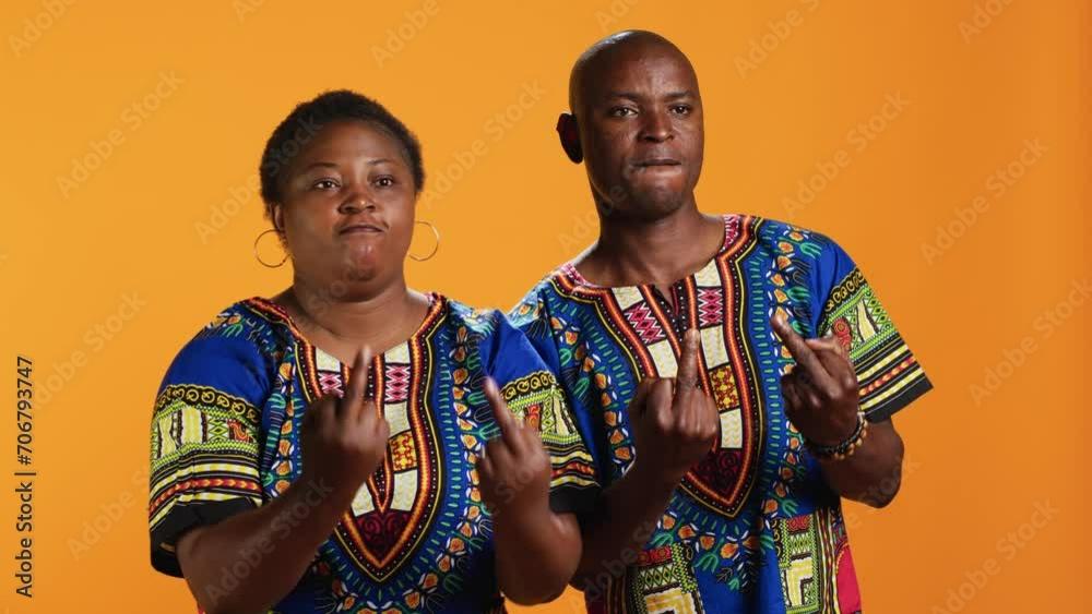 Vidéo Stock Rude ethnic couple showing middle finger in studio, doing ...