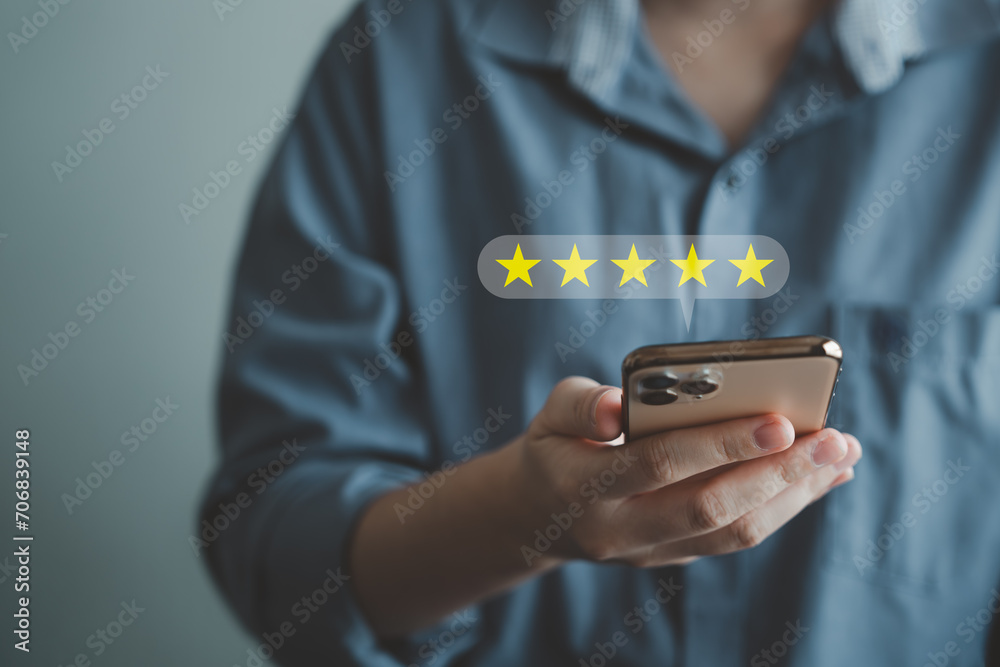 Customer using mobile smartphone for giving satisfaction score with ...