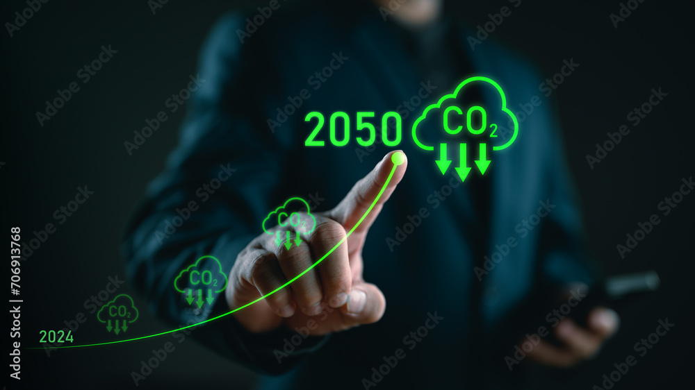 Businessman point to increasing arrow with carbon reduction for decrease CO2, carbon footprint ...