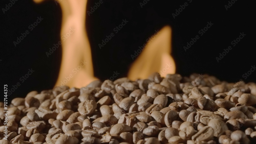 Coffee beans on a black studio background with burning tongues of flame ...