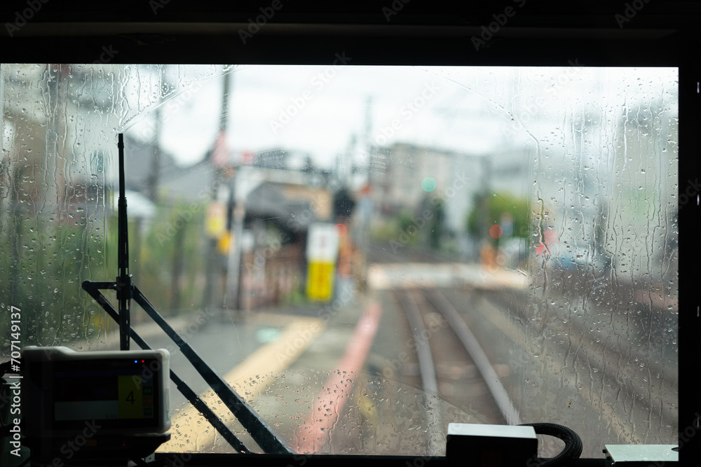 Close-up at train front windscreen with water droplet of surface with ...
